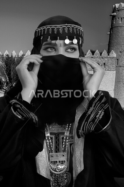 A Saudi Arab Gulf woman wearing the niqab, wearing a traditional ...