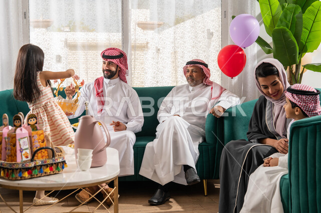 A Saudi Gulf Arab girl presents chocolate pieces on the occasion of the ...