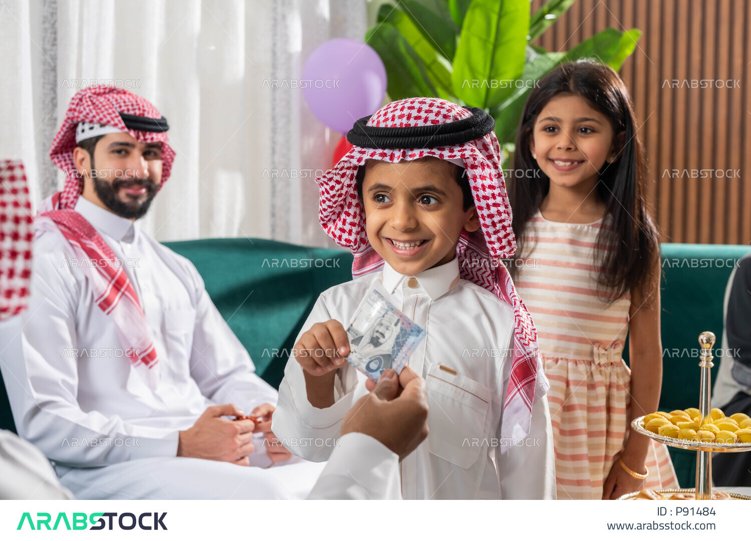 Giving gifts to children, a Saudi Gulf Arab family celebrating the ...