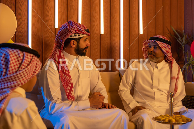 Laughing and communicating with family members, a close-up of two Saudi ...