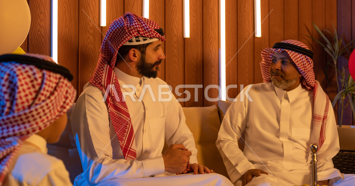 Laughing and communicating with family members, a close-up of two Saudi ...