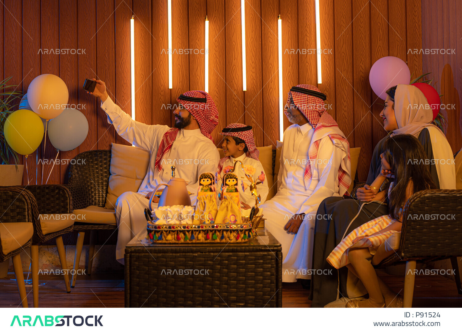 Taking selfies via mobile phone, a Saudi Gulf Arab family celebrating ...