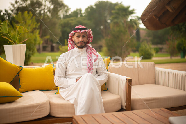 Taking a souvenir photo and looking at the camera, a Saudi Arabian Gulf ...