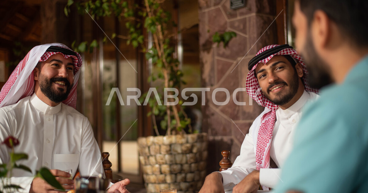 A youthful atmosphere in a Saudi cafe, a close-up of Saudi Gulf Arab ...