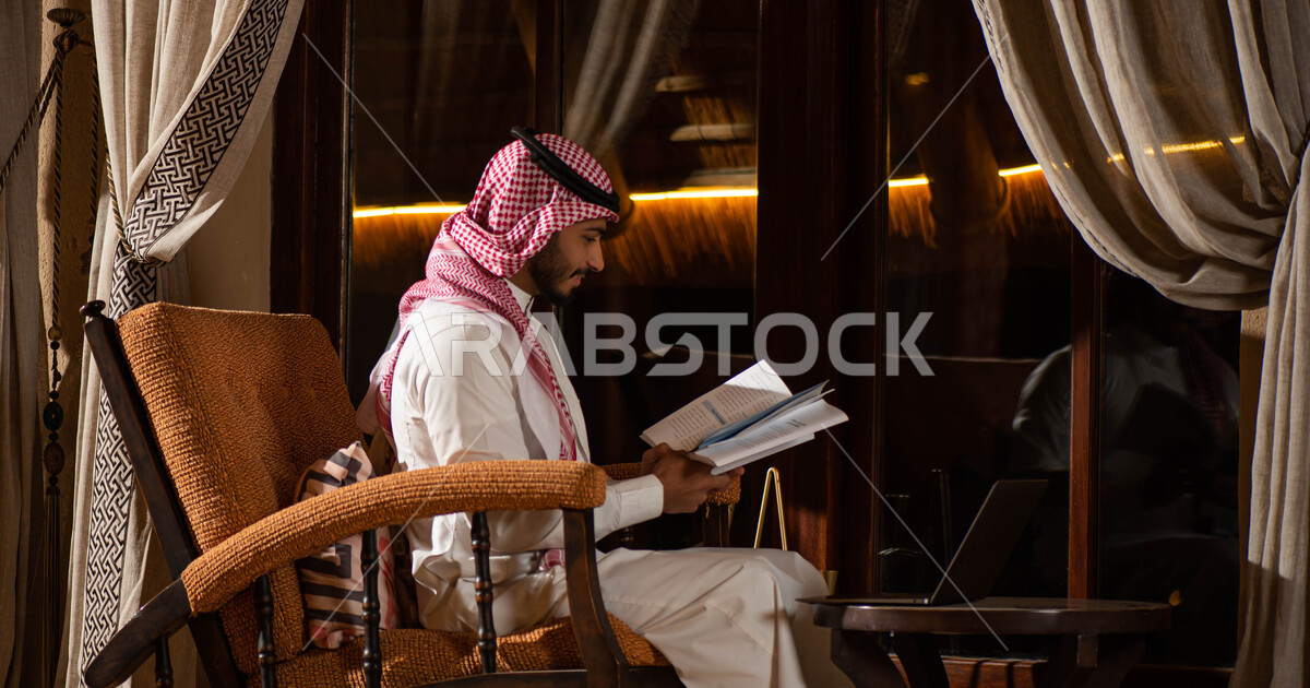 A Saudi Arabian Gulf man dressed in Saudi traditional dress sitting on ...
