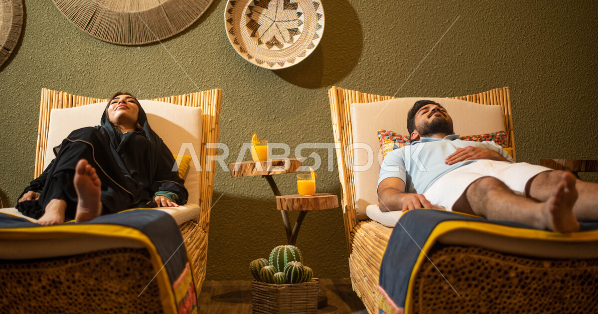 Tourist destinations, a Saudi Arabian Gulf couple sitting on a relaxing ...