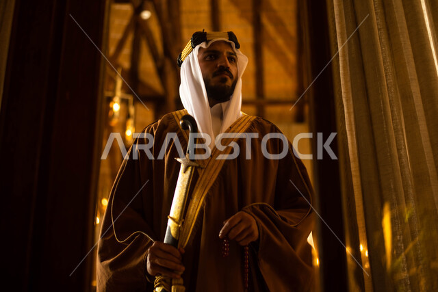 A close-up of a Saudi Arabian Gulf man wearing the traditional folk ...