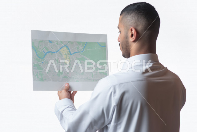 Angled picture of a young Saudi Arabian Gulf Arab tour guide, holding a ...