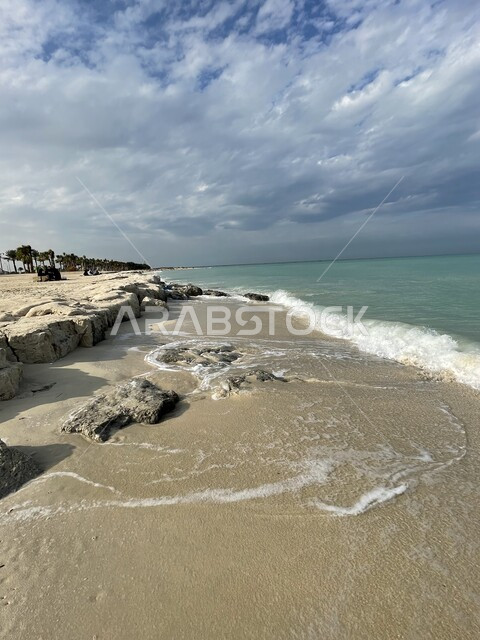 Calm sea waves on Ras Tanura beach in Jubail, Saudi Arabia, cloudy sky ...