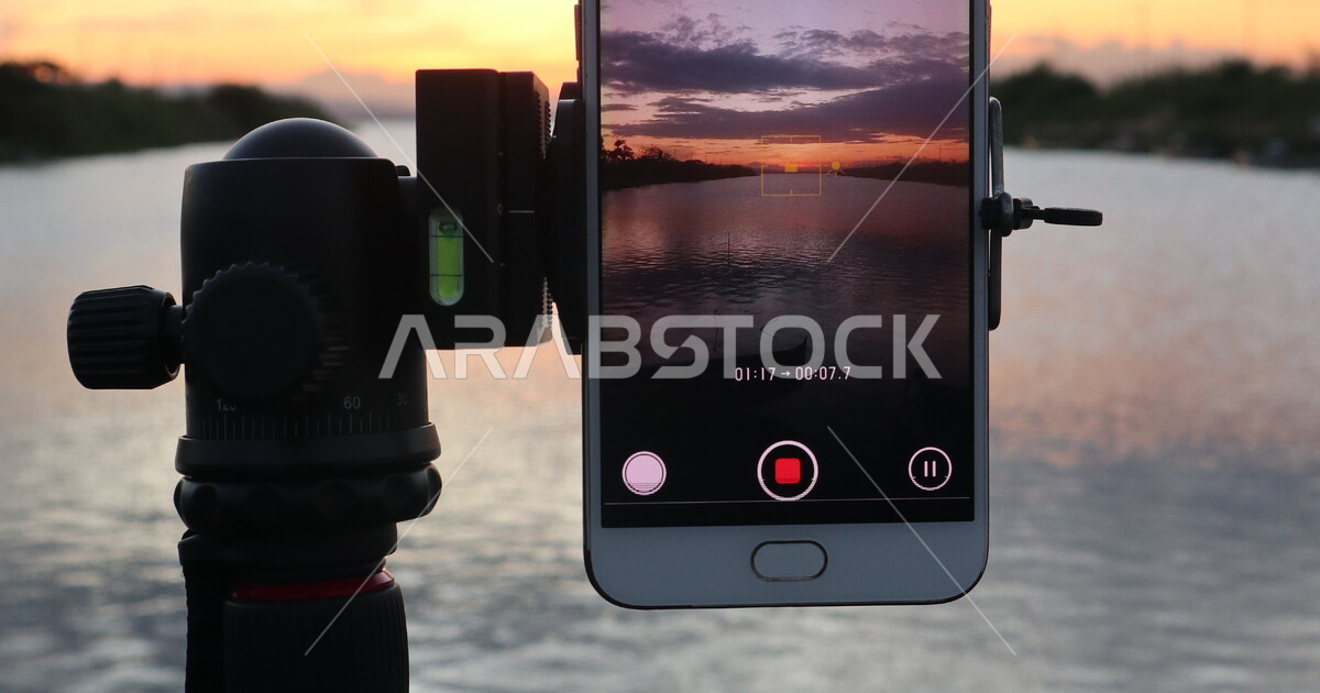 Taking a souvenir photo through the back camera of the mobile phone, a ...