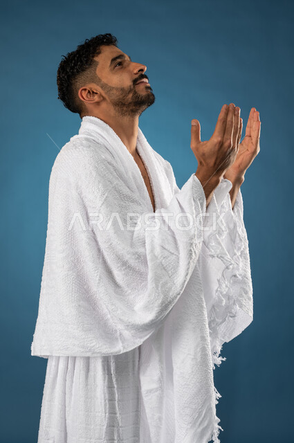 Wearing ihram clothes, a portrait of a Saudi Arabian Gulf Muslim young ...