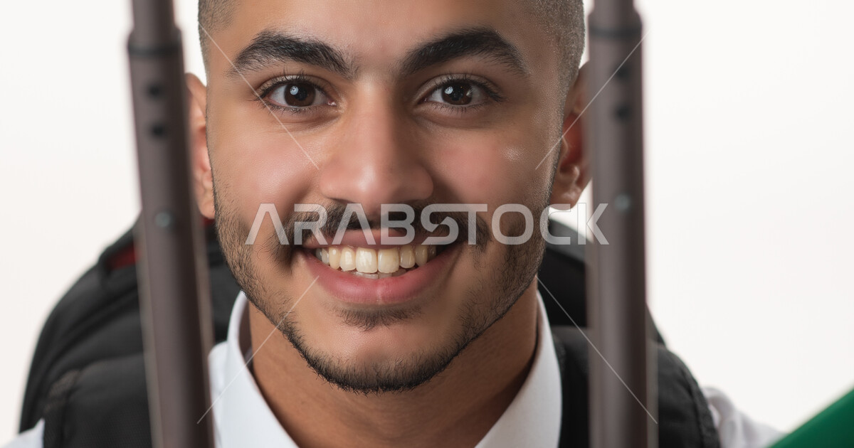 Close-up of a young Saudi Arabian Gulf Arab tourist wearing a backpack ...