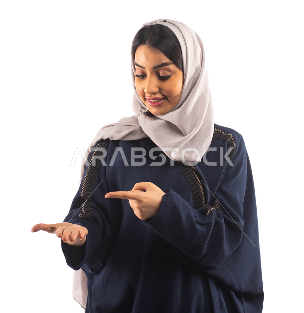 Two hands gestures pointing to something, a portrait of a veiled Saudi ...