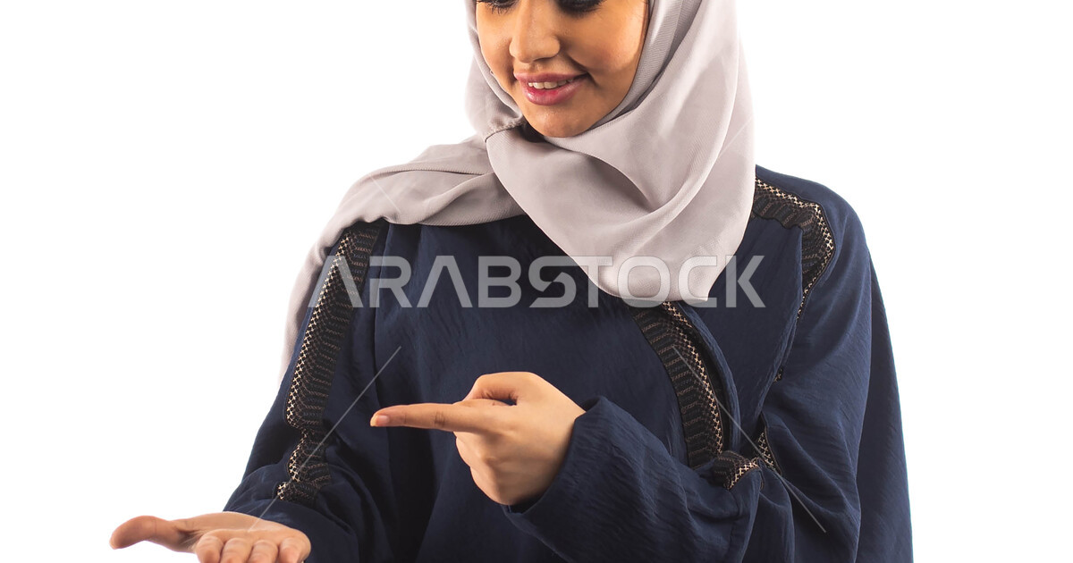 Two hands gestures pointing to something, a portrait of a veiled Saudi ...