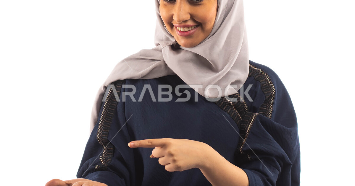 Two hands gestures pointing to something, a portrait of a veiled Saudi ...