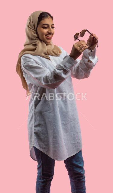 Choosing new suitable glasses, a portrait of a Saudi Arabian Gulf woman ...