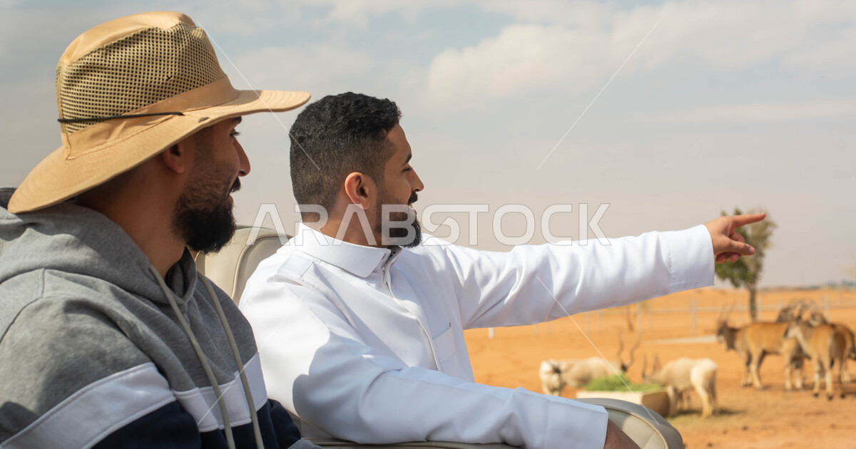 Two young Saudi Arabian Gulf men touring a zoo in the Kingdom of Saudi ...