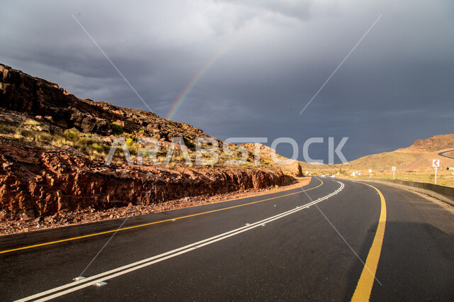The appearance of a rainbow during rain in the sky of the Asir region ...