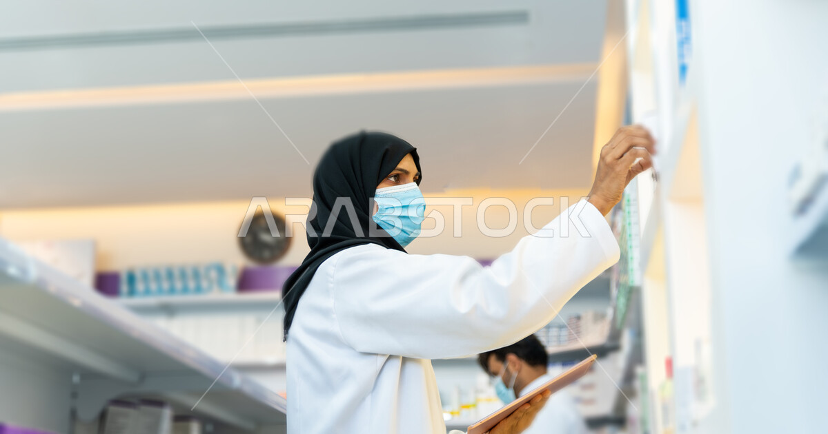 A Saudi Arabian Gulf woman pharmacist wears a mask to prevent corona ...