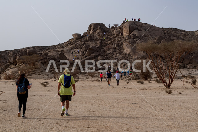 Hiking, a group of young Saudi Gulf Arabs climbing mountains, walking ...