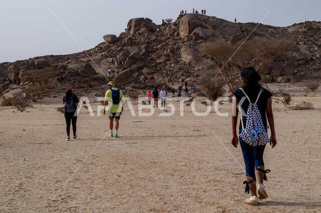 Hiking, a group of young Saudi Gulf Arabs climbing mountains, walking ...