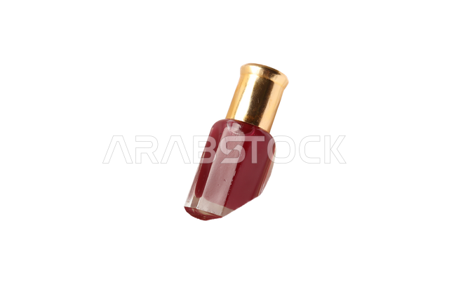 A glass tola of the original Oud oil on a piece of white silk, perfume ...