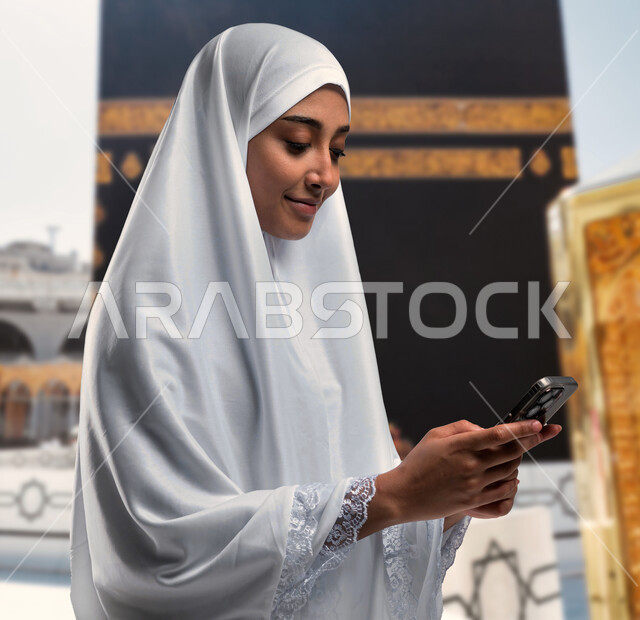 Using the Hajj and Umrah guide application on a mobile phone, a Saudi ...