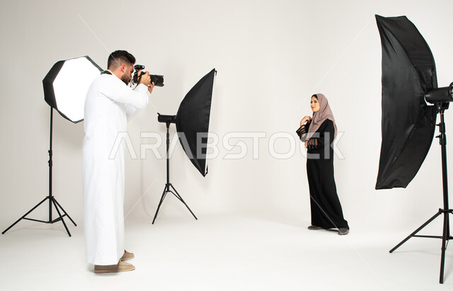 Portrait of a photo session in the studio, a professional Saudi Arabian ...