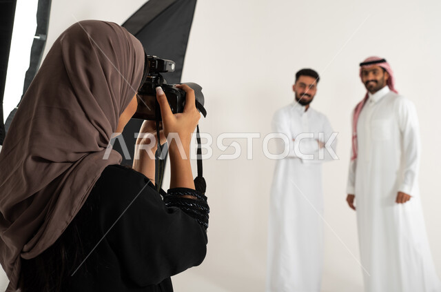 Portrait of a photo session in the studio, two men dressed in ...