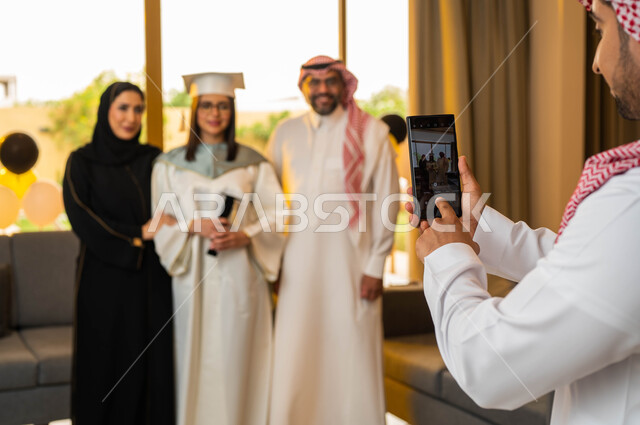 A university graduate wearing graduation clothes and holding a ...