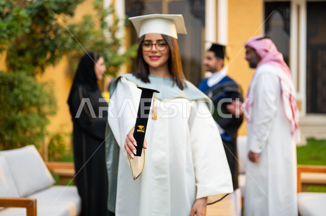A happy Saudi Gulf Arab family celebrates the graduation of its ...