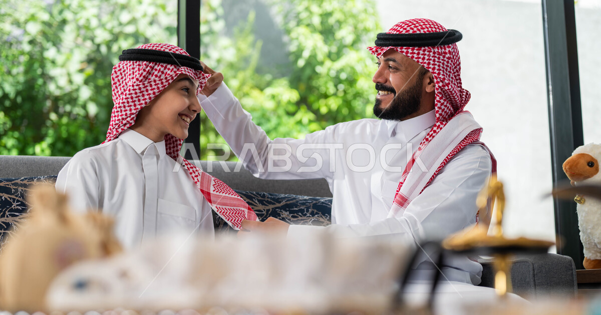Communicating and laughing with family members, a young Saudi Arabian ...