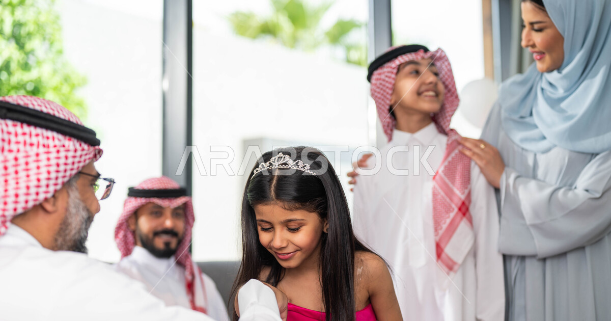 Respect and appreciation for parents, a Saudi Arabian Gulf girl kissing ...