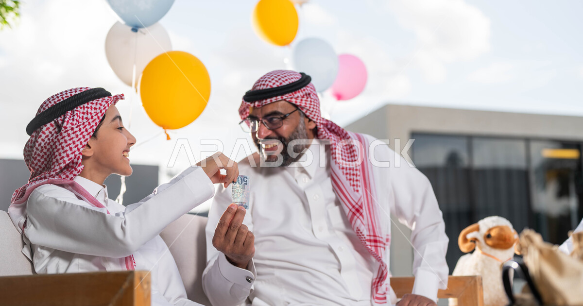 Presenting Eidiya to children, an elderly Arab Gulf Saudi man ...