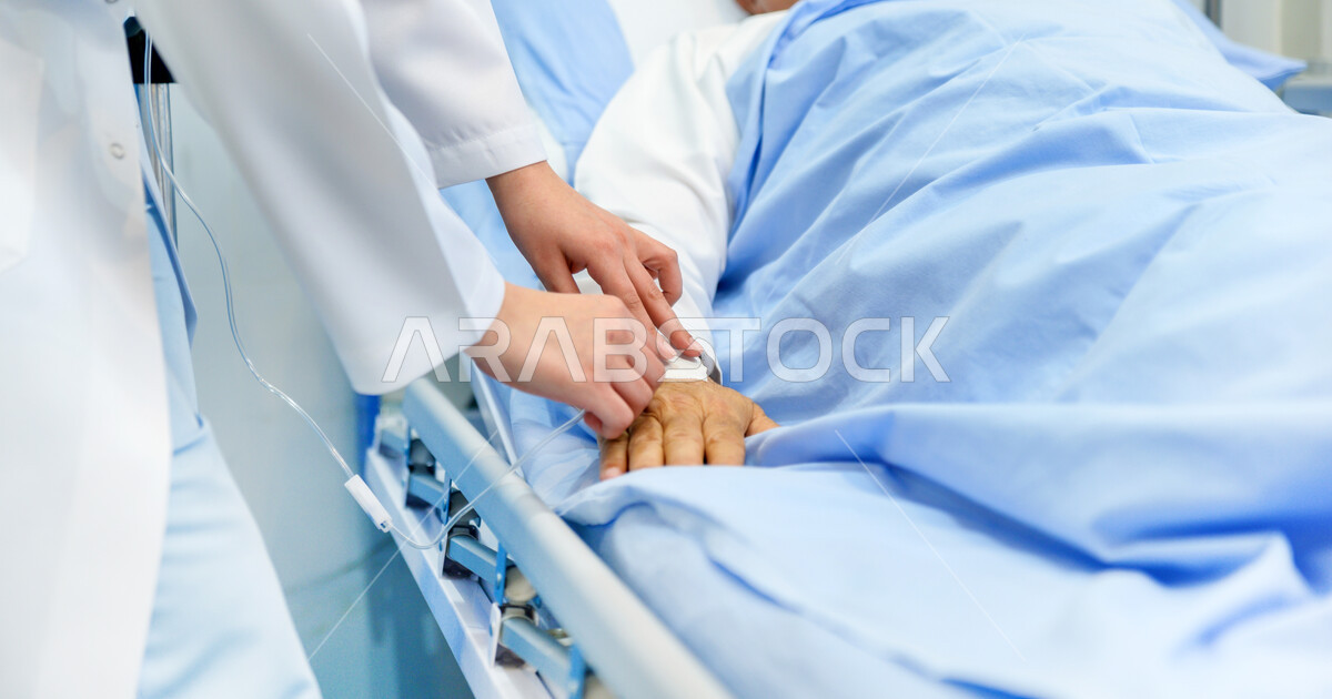 An old man, Arab, Gulf, Saudi, patient lying on a hospital bed ...