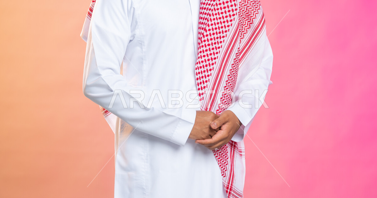 Portrait of a handsome young man wearing the traditional Saudi thawb ...