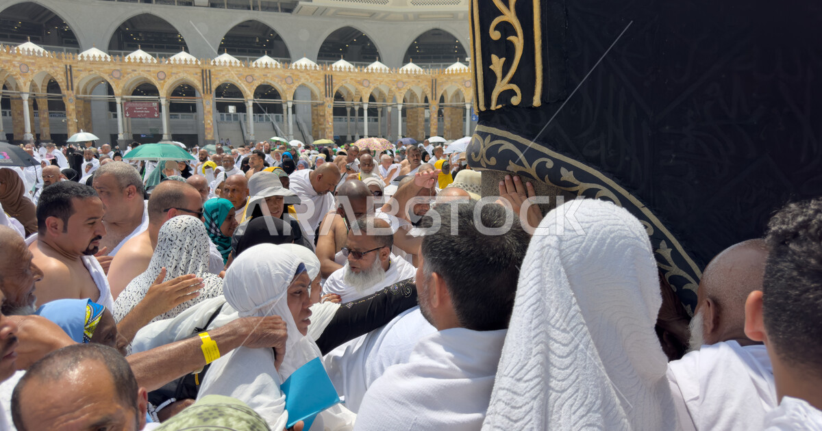 A close-up of the pilgrims of the Sacred House of God near the door of ...