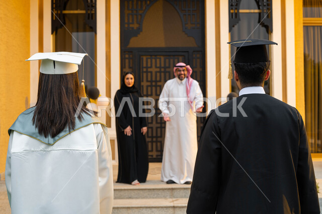 A happy Saudi family, a Saudi Gulf Arab woman and man celebrating the ...