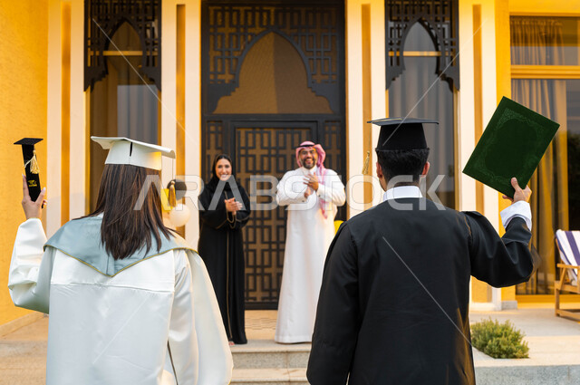 A happy Saudi family, a Saudi Gulf Arab woman and man celebrating the ...
