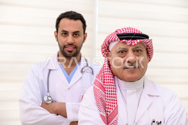 Two Saudi Arabian Gulf doctors standing with their hands full ...