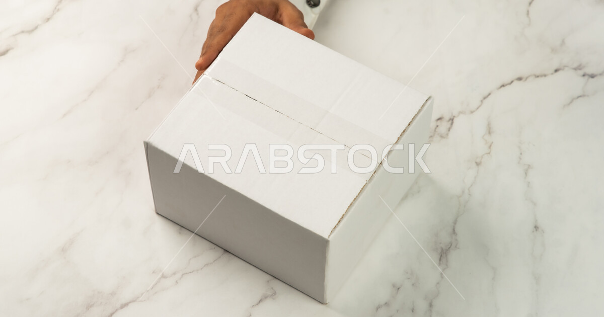 Mockup of a wrapped carton box on a white marble table, a close-up of a ...