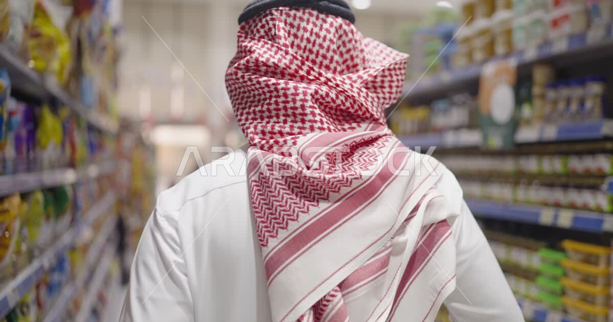 Photography from the back of an Arab Gulf man shopping from the crisps ...