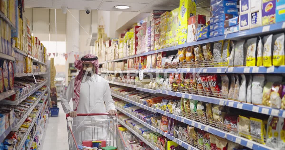 A Saudi Arabian Gulf man in the crisps section inside the supermarket ...