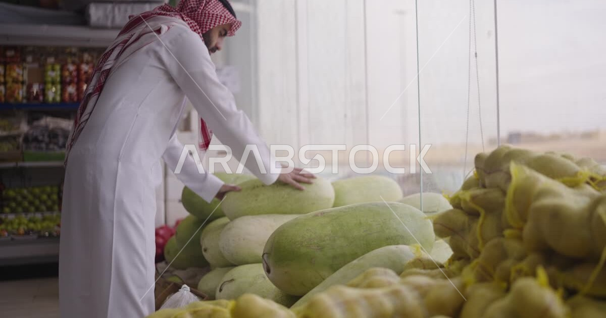 A Saudi Arab Gulf man buys green squash, the vegetables section inside ...