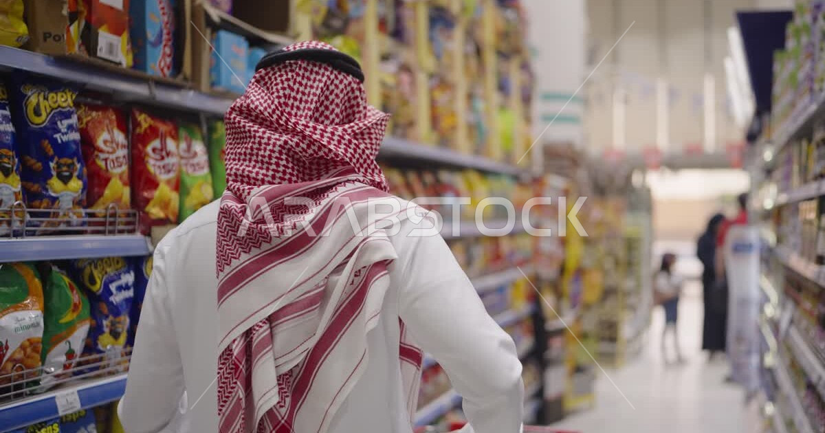 Photography from the back of a Saudi Arab Gulf man buying household ...