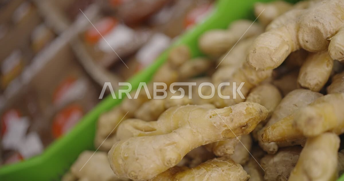 Close-up of a Saudi Arabian Gulf man shopping for ginger from the ...