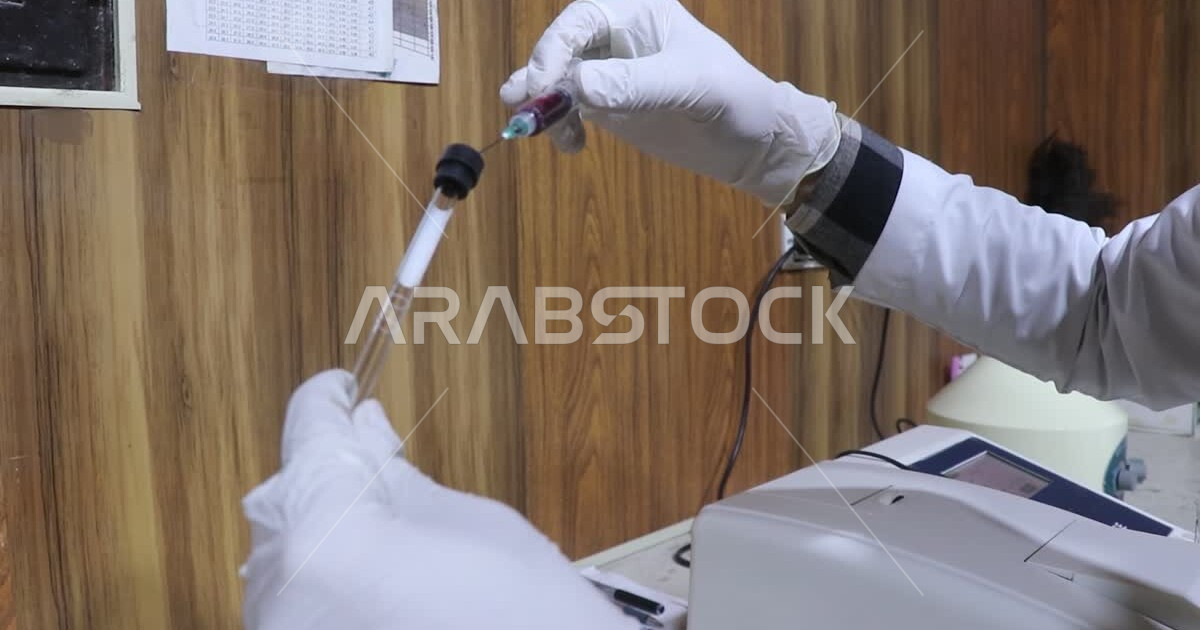 Close-up of a laboratory doctor transferring blood into a test package ...