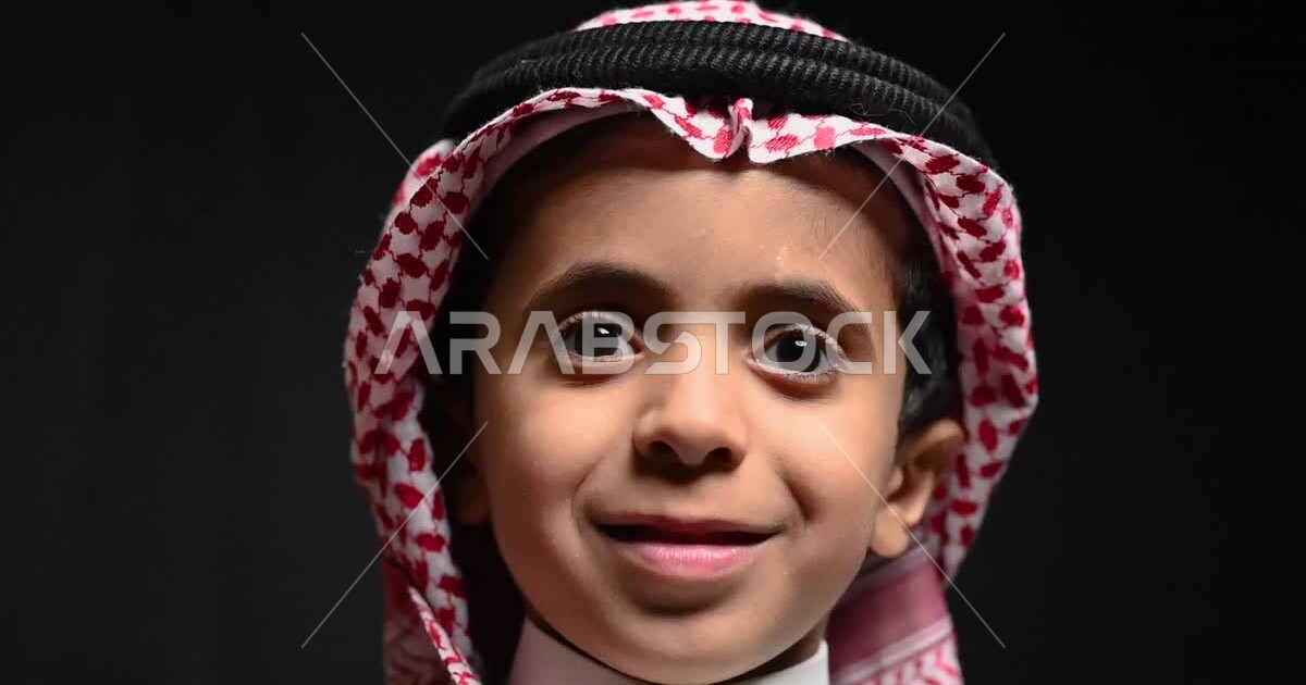 Close-up of a Saudi Arabian Gulf child with happy facial gestures ...