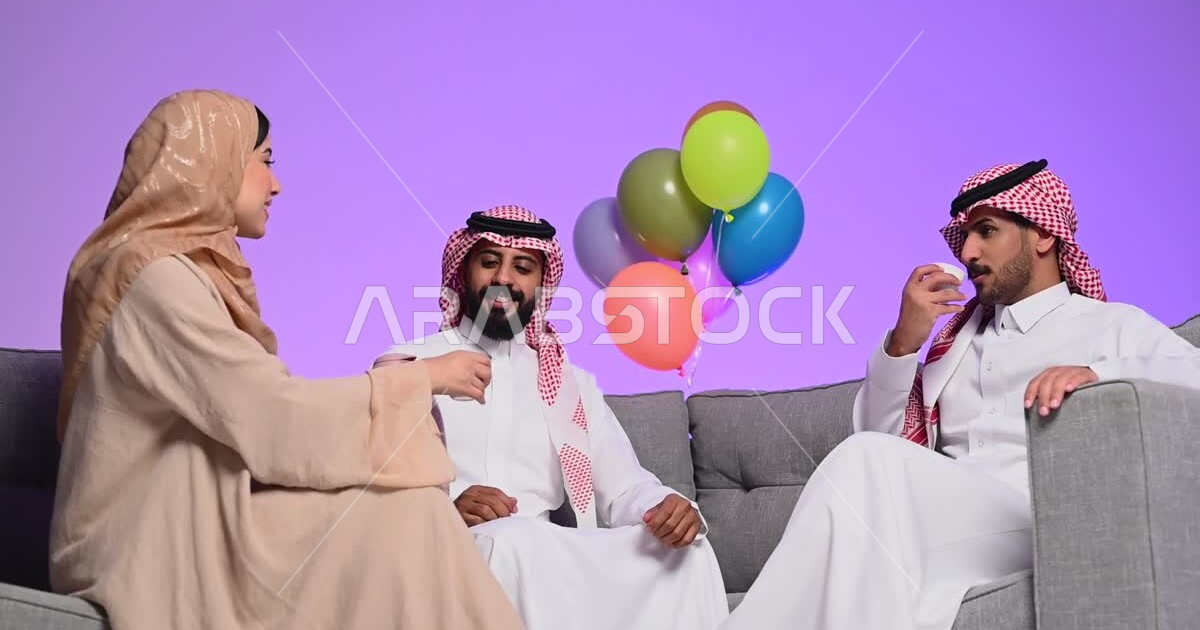 A Saudi Arabian Gulf woman serving coffee to guests, honoring the guest ...