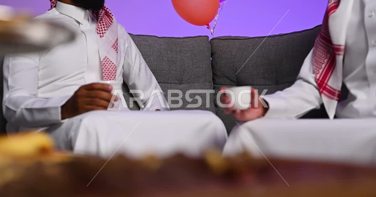 Close-up of two Saudi Arabian Gulf men dressed in traditional Saudi ...